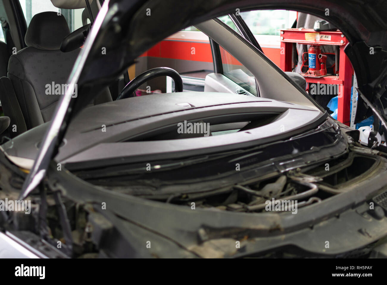 Disassembly and replacement of the windshield in a passenger car Stock ...
