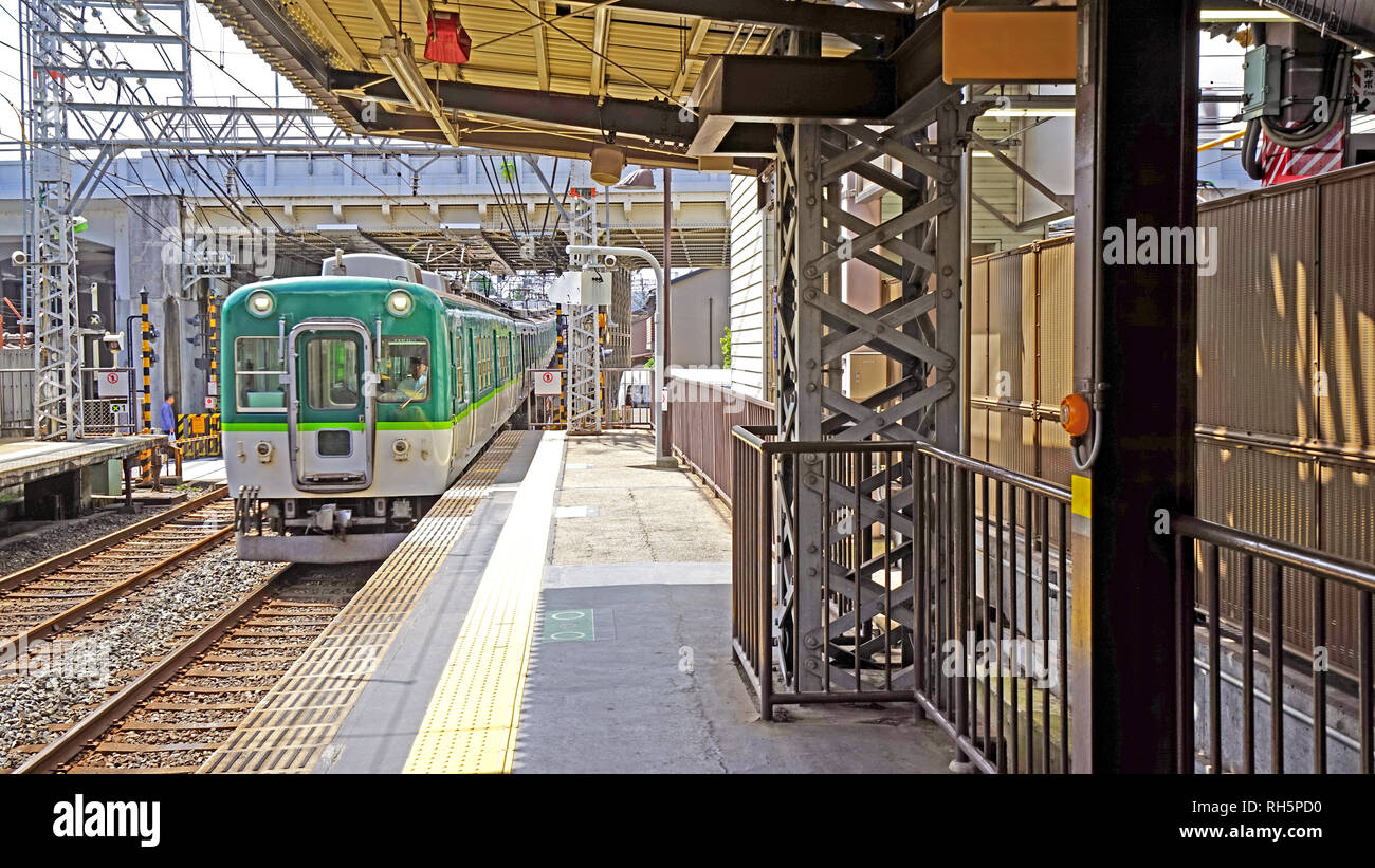 The green Japanese train, railway track and station in Japan Tokyo ...