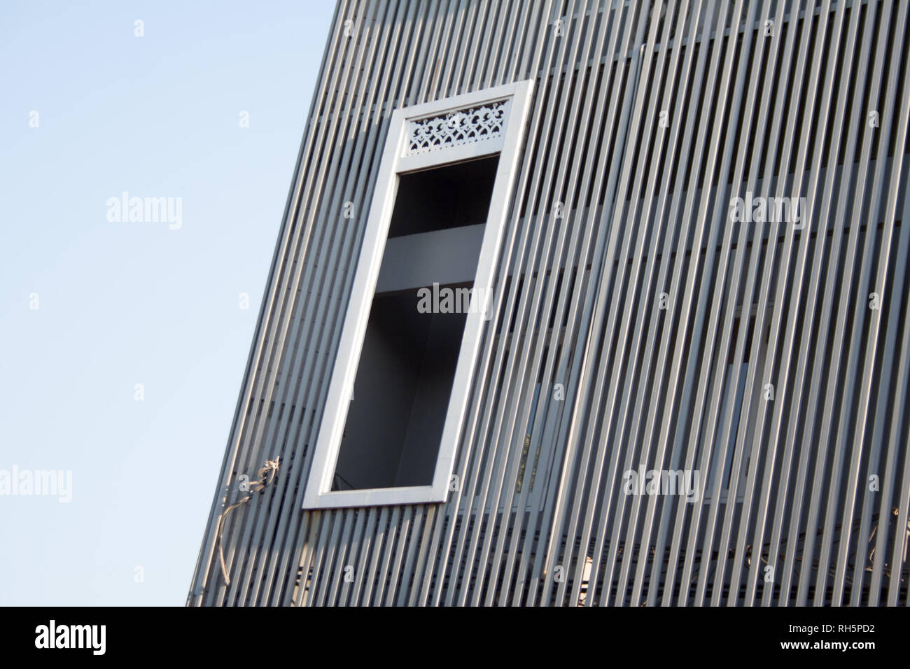 Building facade detail with vertical shutters and white window frame on ...