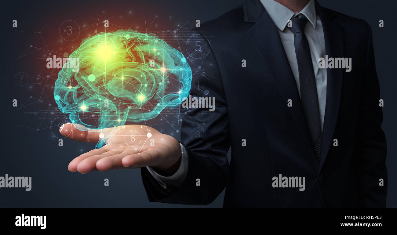 Businessman holding human brain on his hand with logistics symbols ...