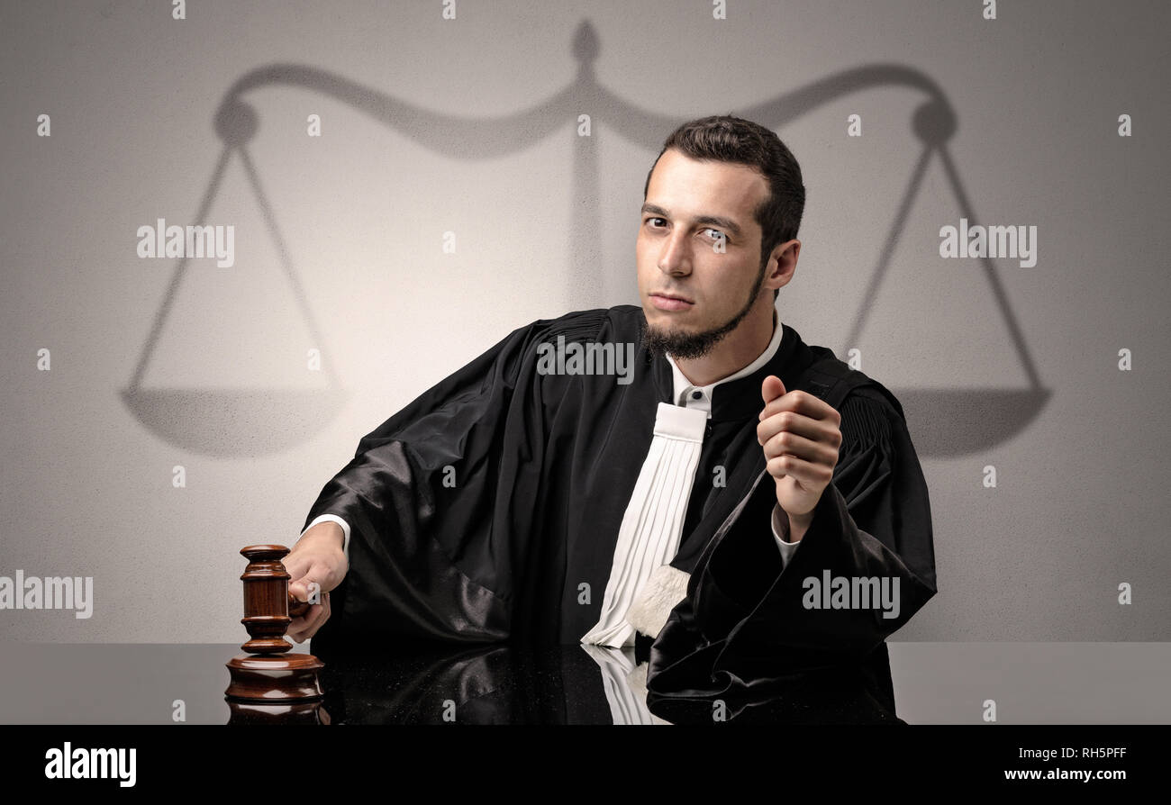 Young handsome judge in black gown making decision Stock Photo - Alamy