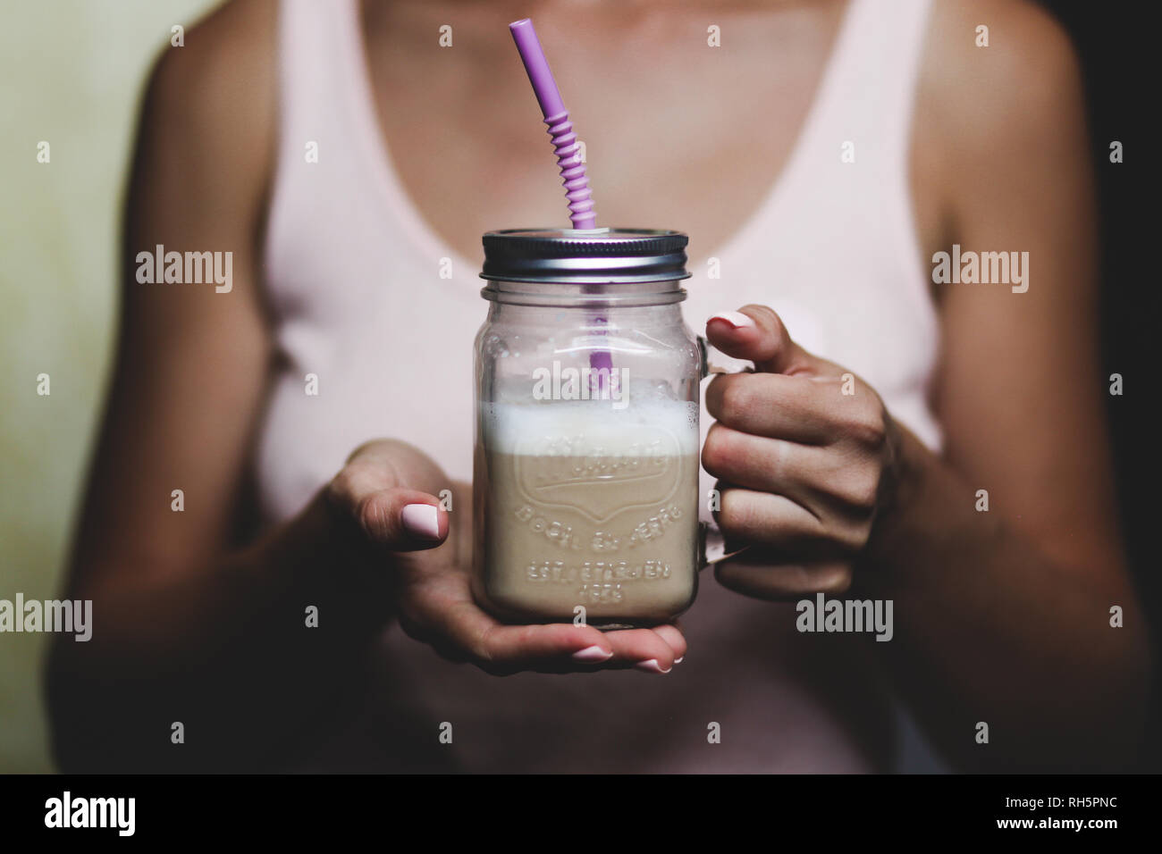 Woman's hands holding delicious milk cacao in mason jar. Space for text ...