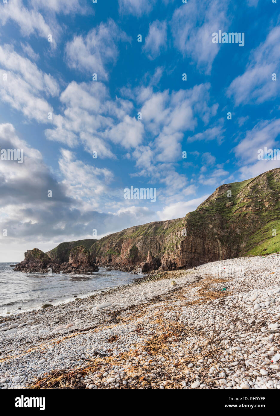 Cliffs, sea stacks, shingle beach and cove at Bloody Foreland, at the ...