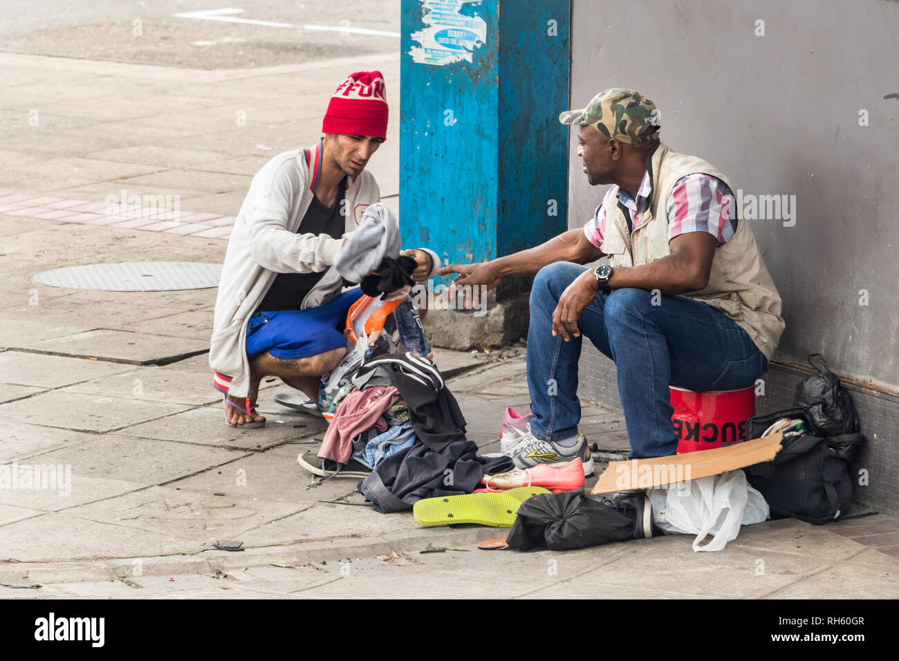 Durban, South Africa - January 6th, 2019: Two men trading clothes in ...