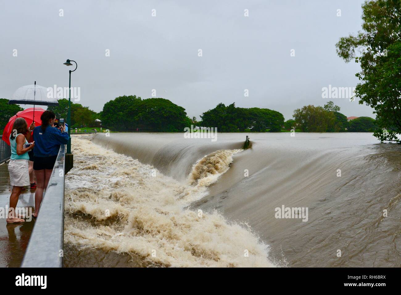 Crowds of people watching the Ross River flood at Aplin's weir ...