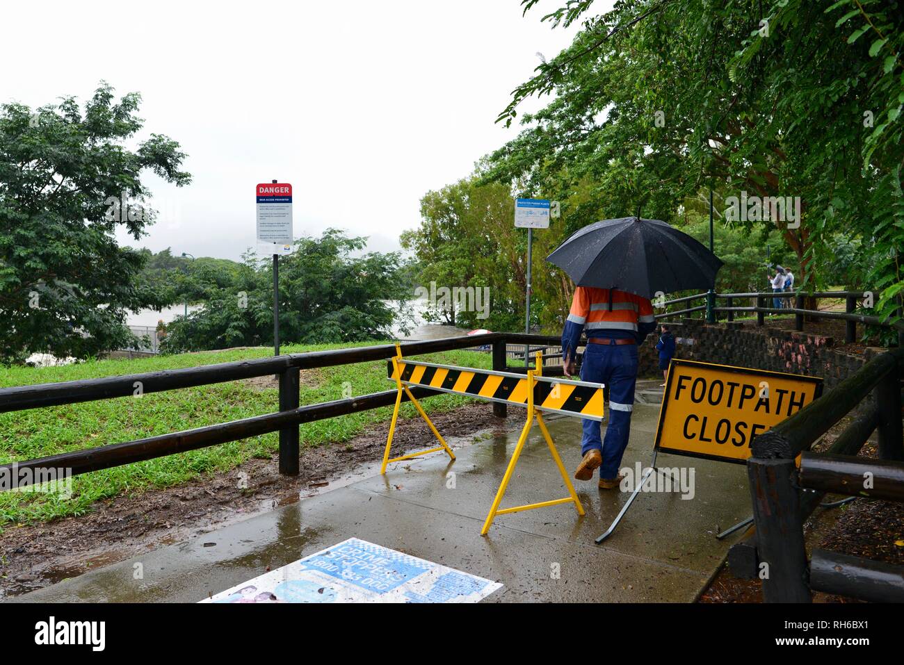 A man walking around a footpath closed sign hi-res stock photography ...