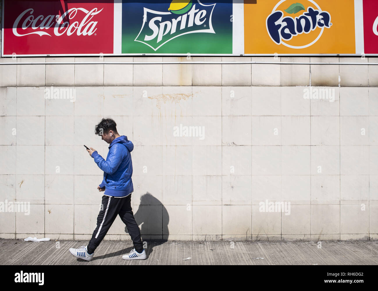 January 29, 2019 - Hong Kong - A commuter seen walking past a Coca-cola ...