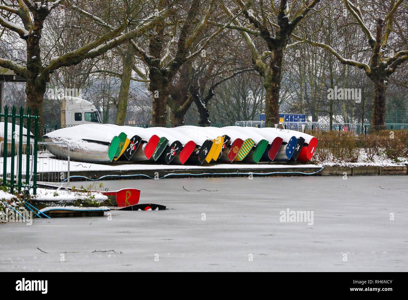 London, UK 1 Feb 2019 - Coloured rowing boats covered in snow near a ...
