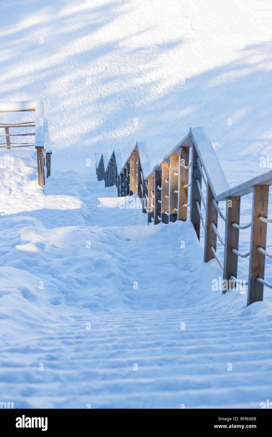 Outdoor stairs full of ice and snow.The wooden stairs in the mountain ...