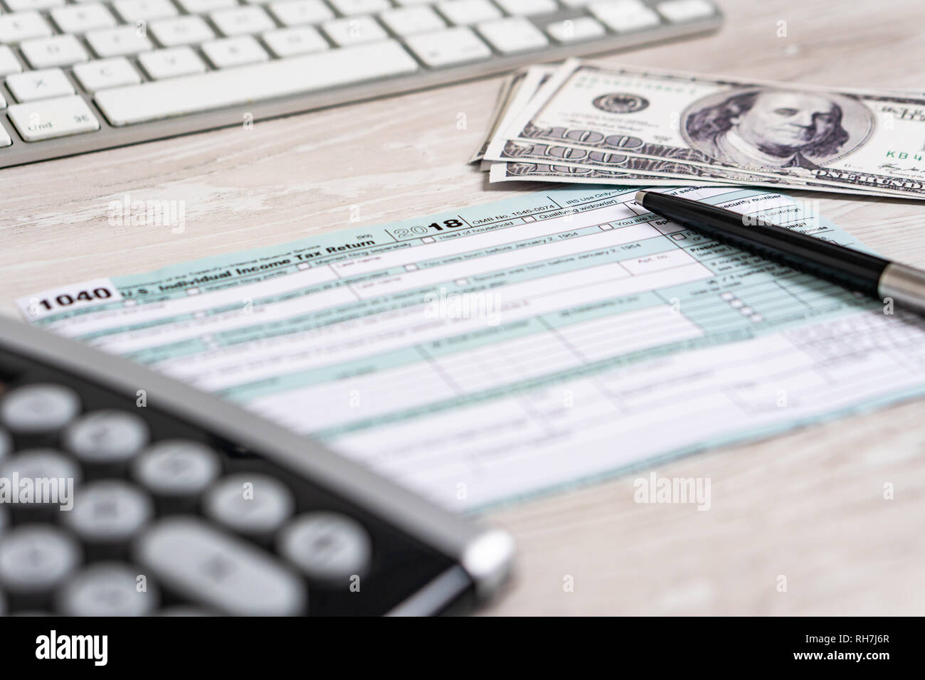 US tax form 1040 with pen, calculator and dollar bills. tax form law ...