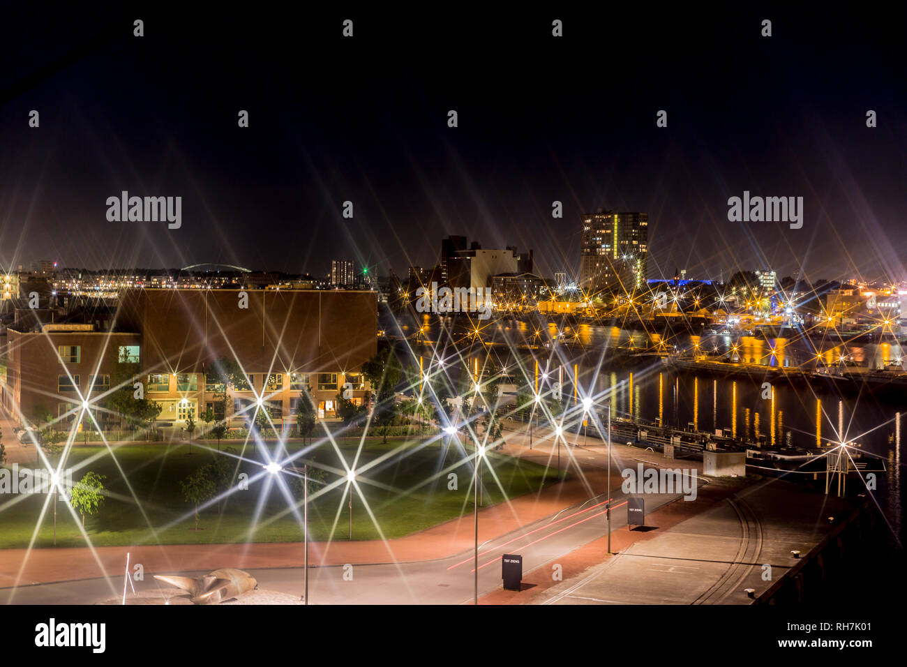 Night view of the city of Rotterdam with reflection of white and yellow ...