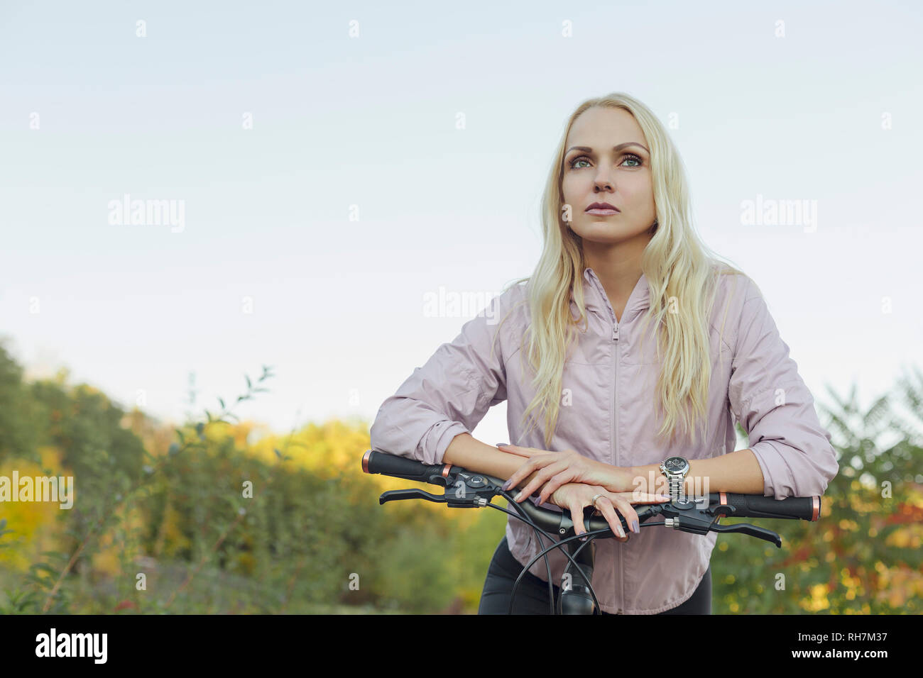 Thoughtful woman standing bicycle hi-res stock photography and images ...