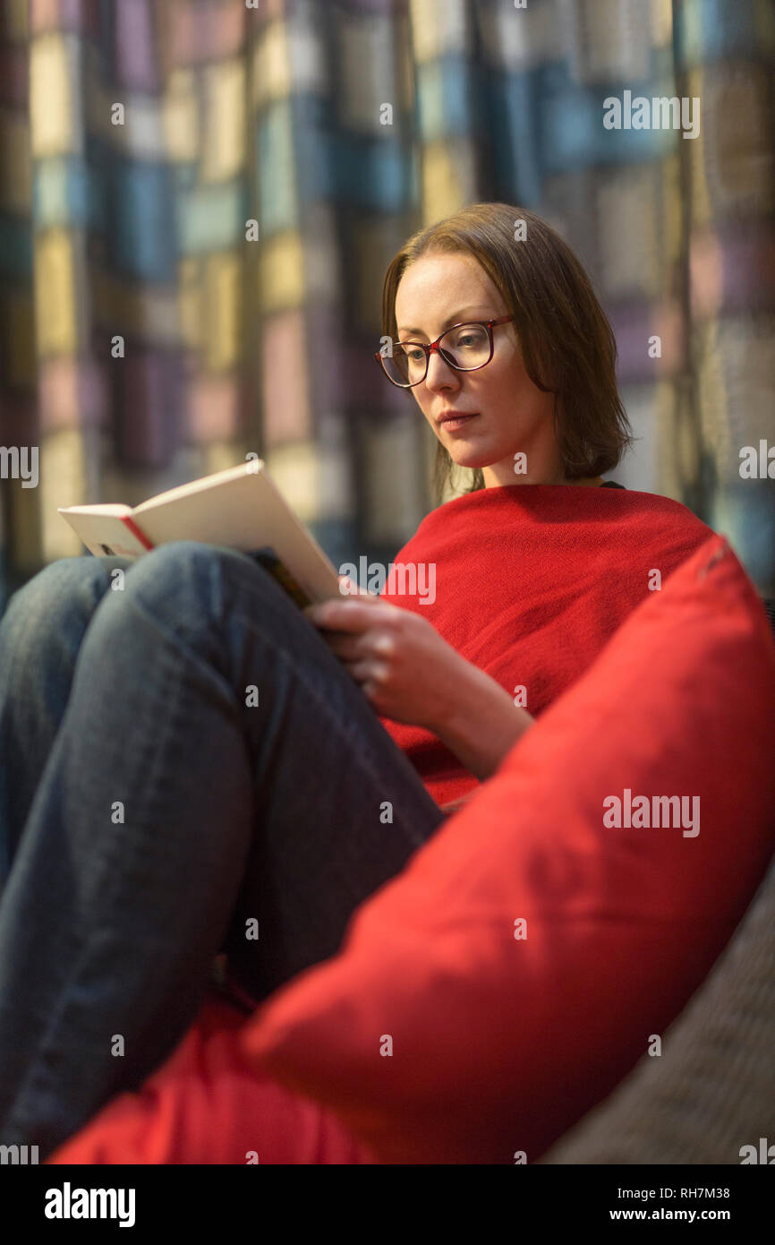 Woman reading book, relaxing Stock Photo - Alamy