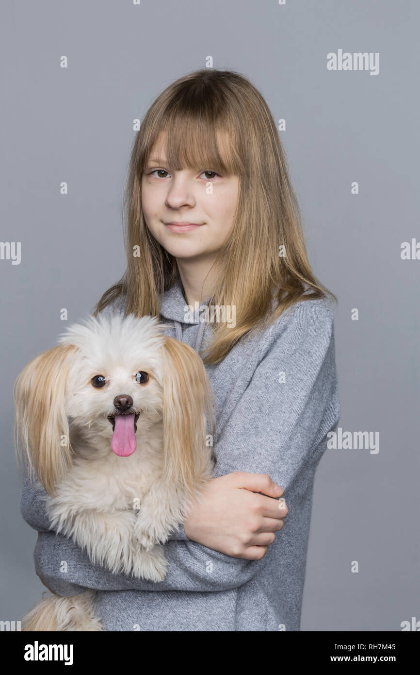 Portrait smiling tween girl holding dog Stock Photo - Alamy Portrait smiling tween girl holding dog Stock Photo - Alamy