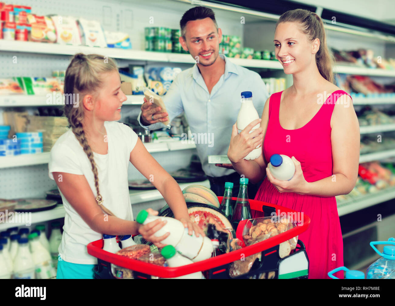 Family with child are selecting milk in supermarket Stock Photo - Alamy