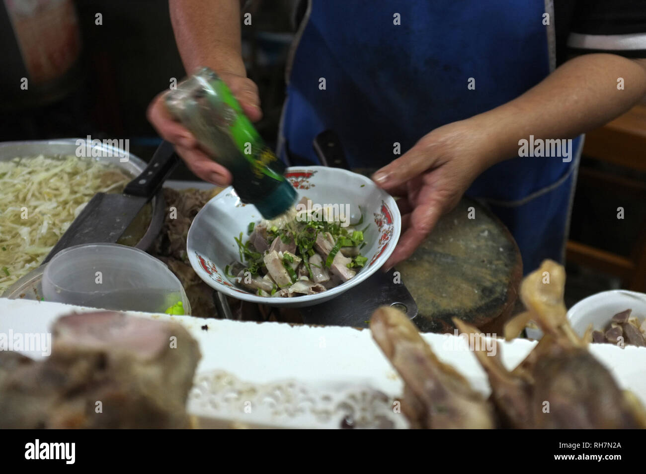 Chef cooking noodle with pork and pork entrails in local restaurant ...