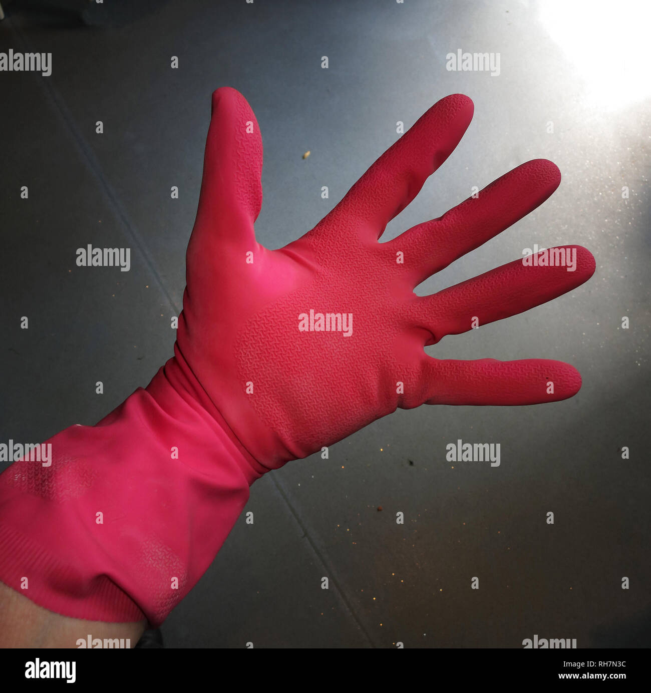 Woman wearing red washing up glove Stock Photo - Alamy