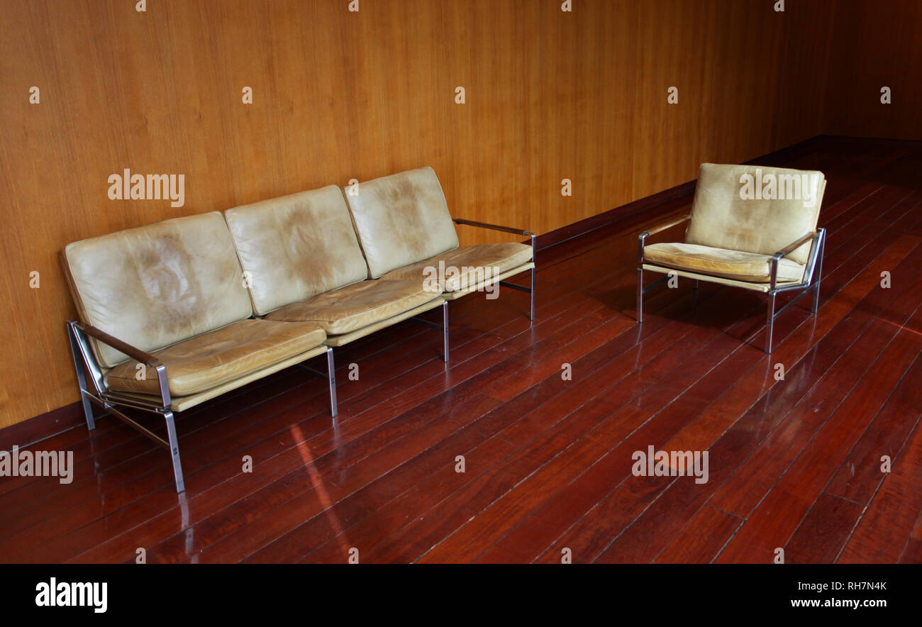 Empty waiting room with leather chair and sofa Stock Photo - Alamy