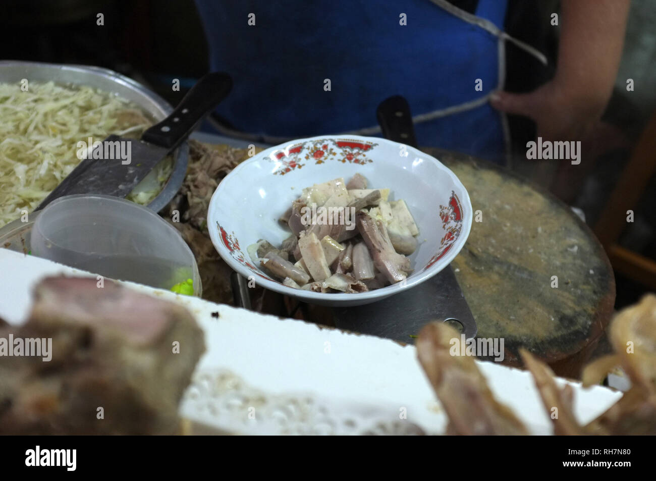 Chef cooking noodle with pork and pork entrails in local restaurant ...