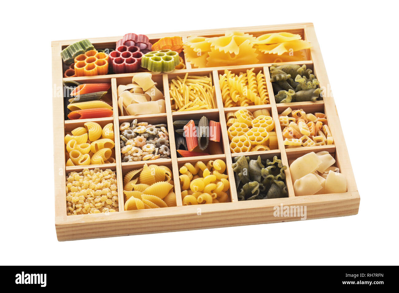 Set of pasta of various shapes and colors in a wooden box, isolated on ...