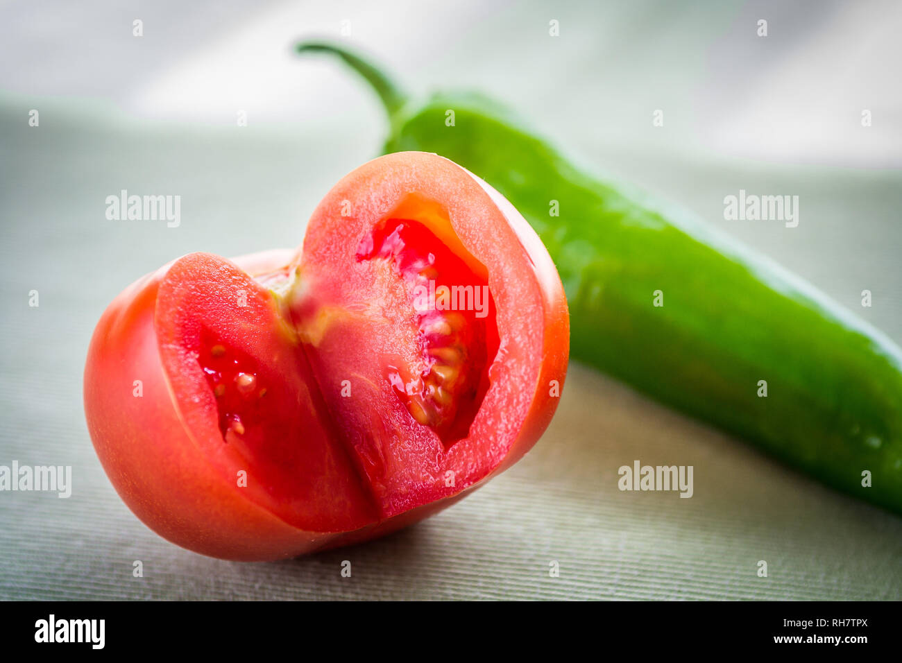 Red tomato and green pepper Stock Photo - Alamy