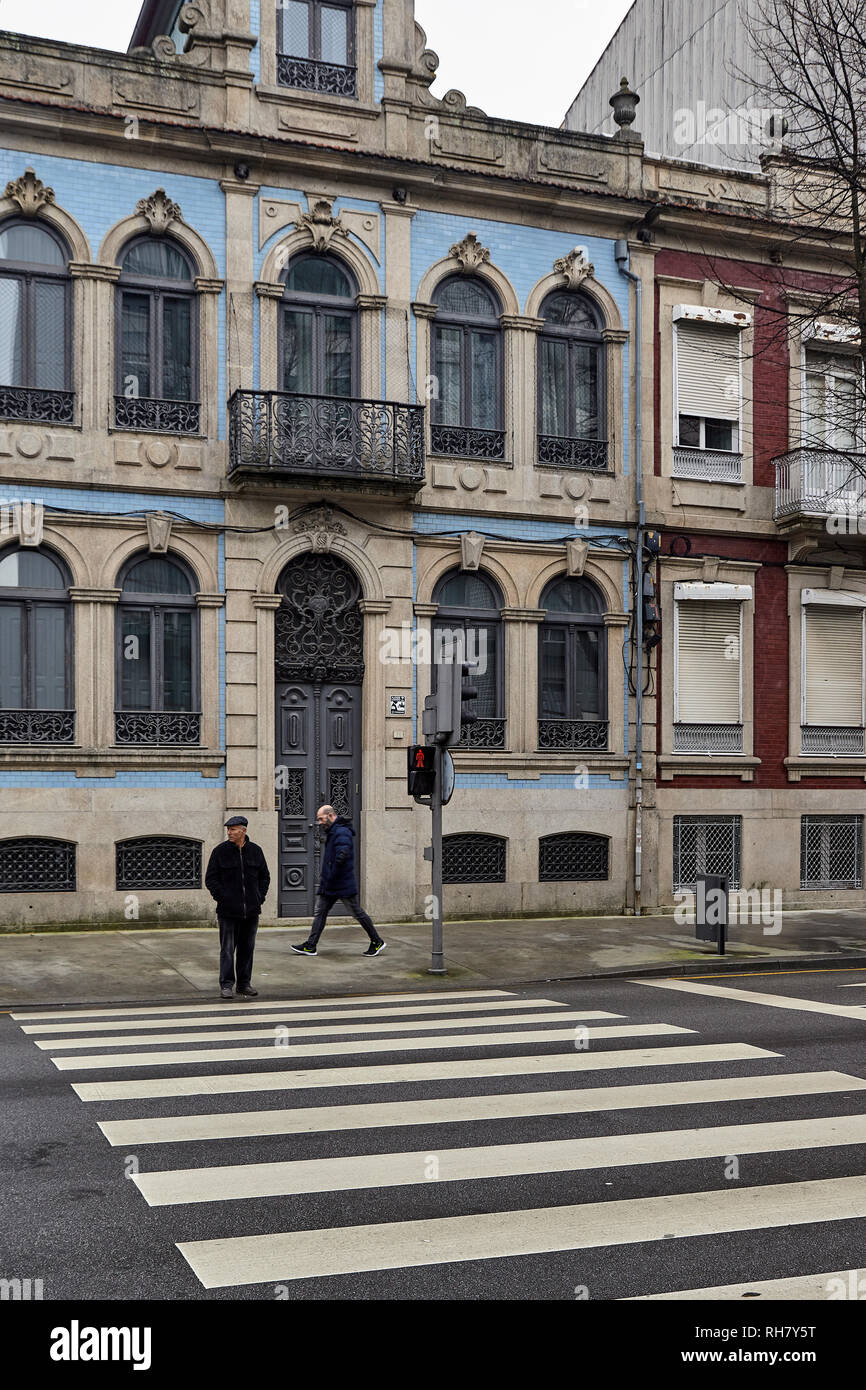 People walking through the typical streets of the city center of Porto ...