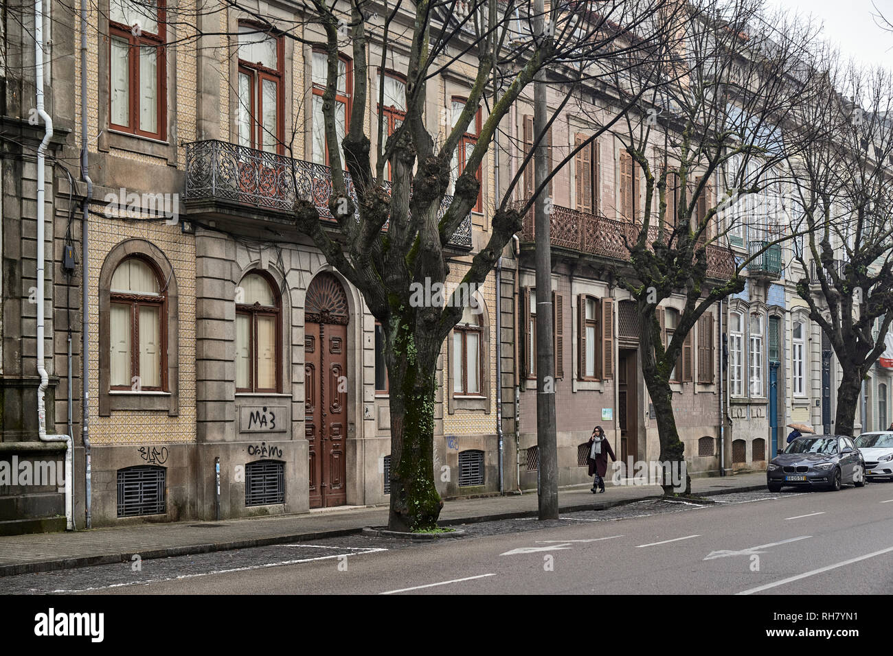 People walking through the typical streets of the city center of Porto ...