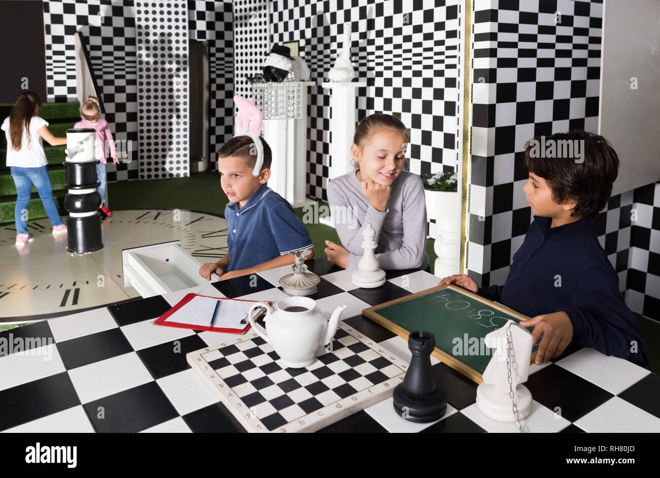 Captured kids play in lost room in chess style Stock Photo - Alamy