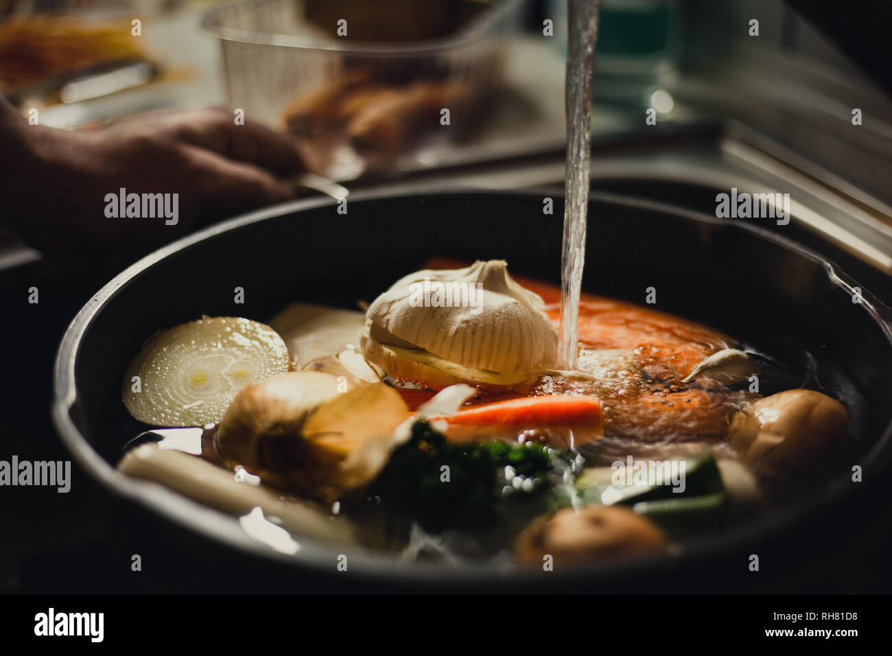 Clear Chicken broth with pieces of under the water tap. Chicken Soap ...