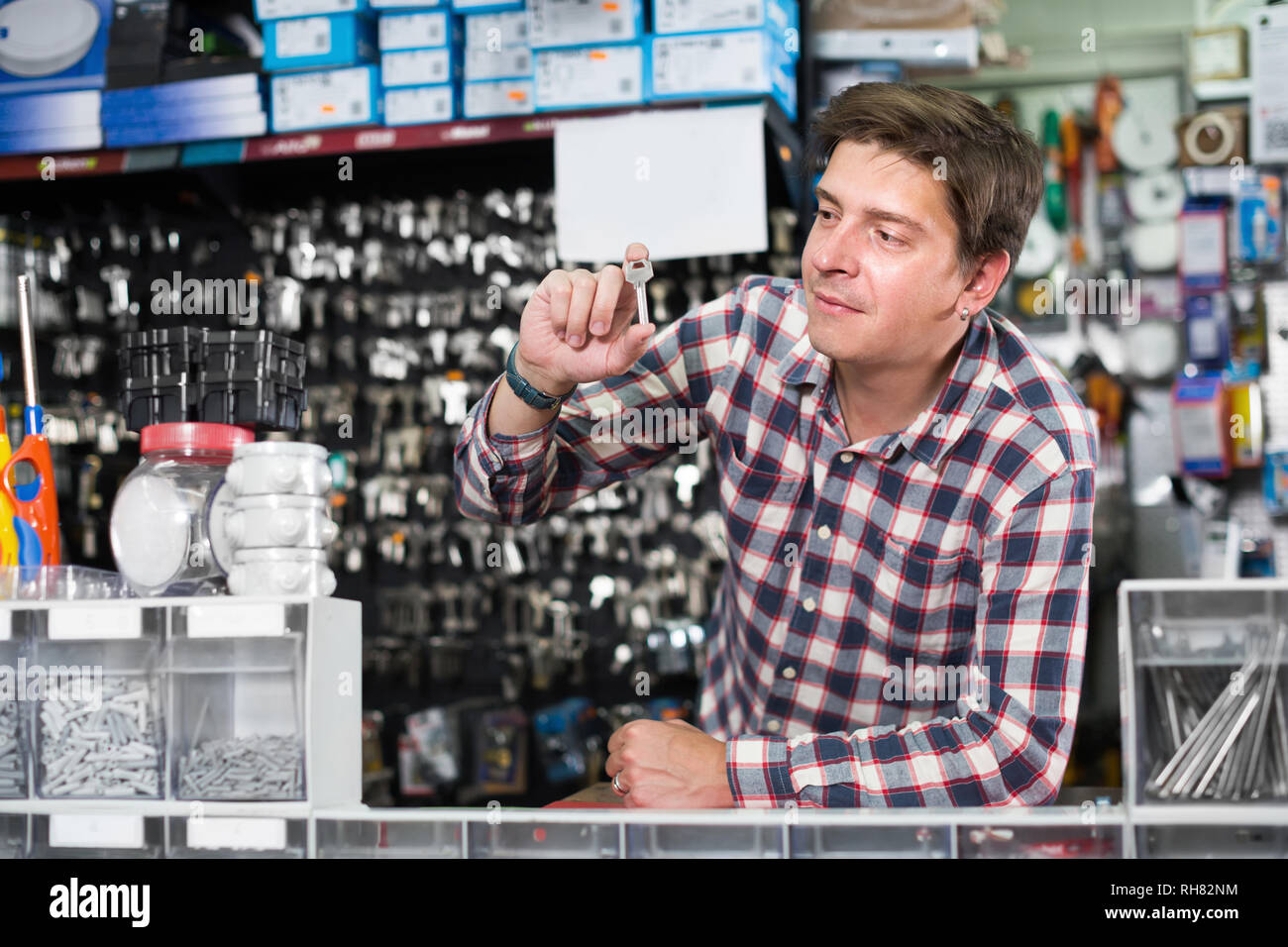 Positive seller manufacturing keys in hardware store Stock Photo - Alamy