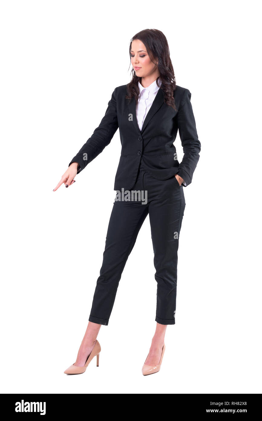 Confident business woman pointing finger down showing empty copy space ...