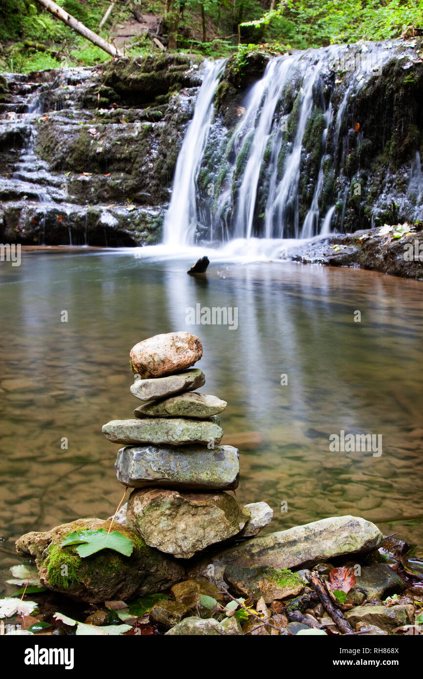 Balanced stones on a waterfall Stock Photo - Alamy