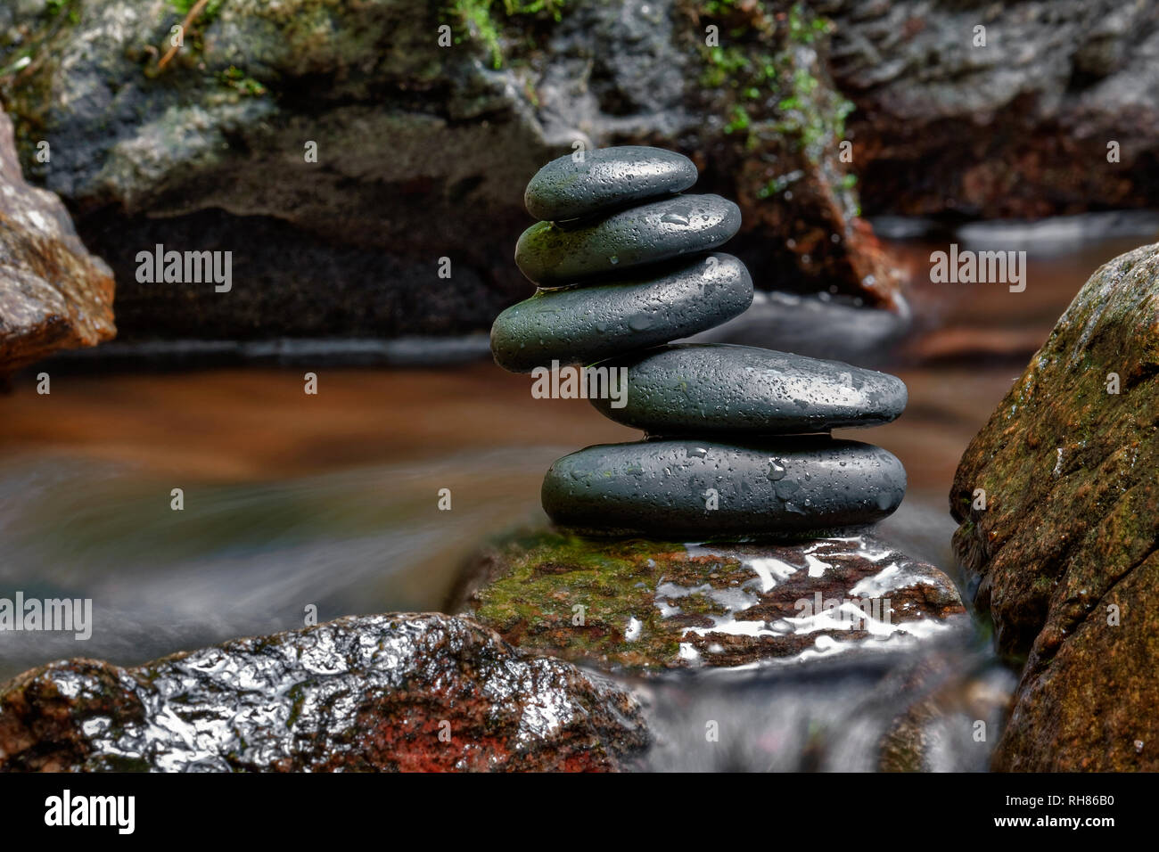 Balanced stones on a waterfall Stock Photo - Alamy