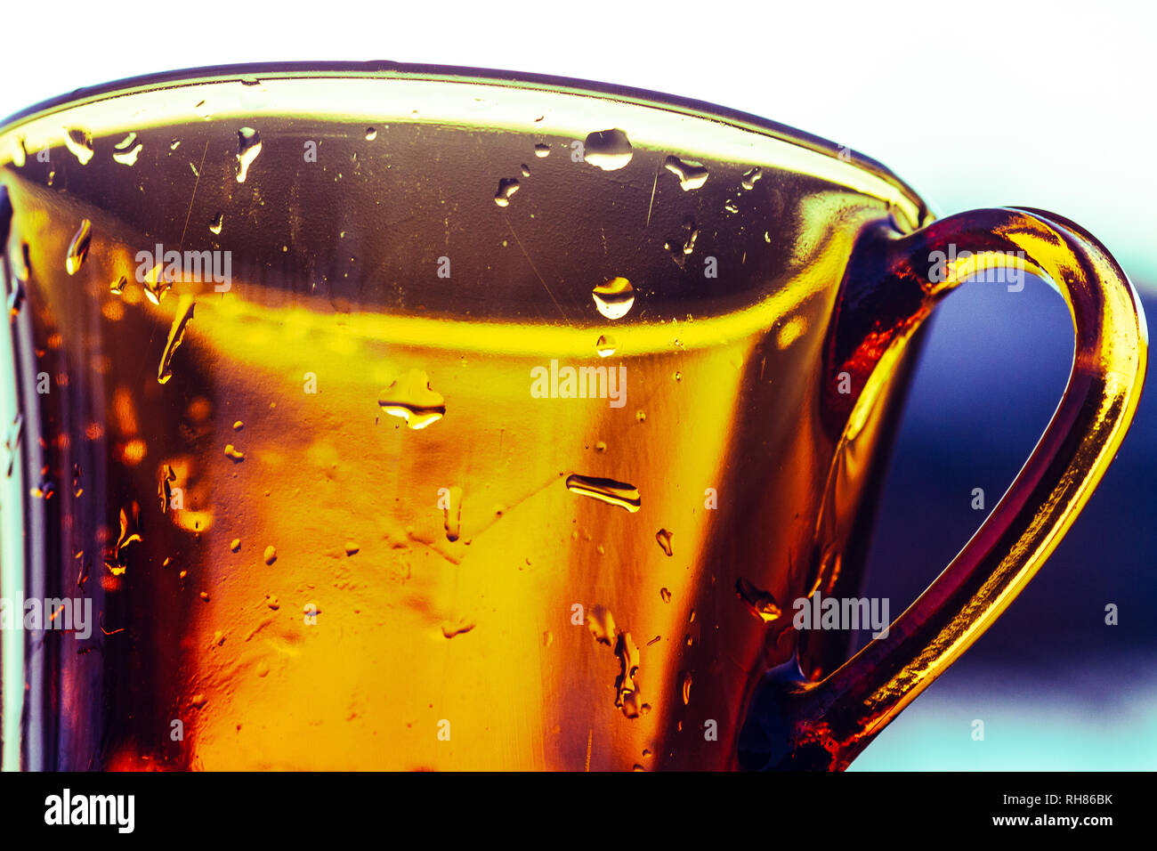 throwing water into a yellow glass Stock Photo - Alamy