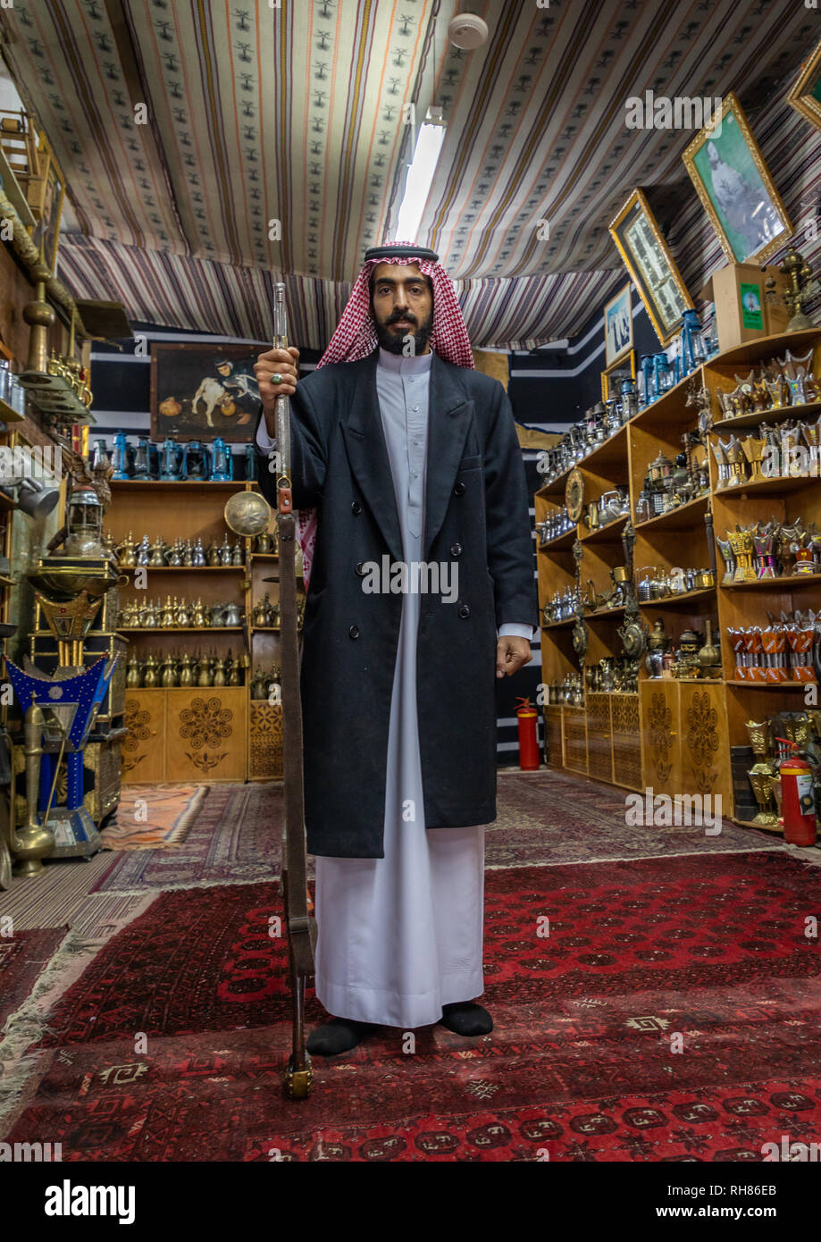 Saudi man buying a traditional sword in a shop, Al-Bahah region, Al ...