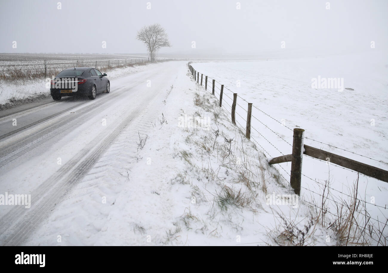 A car makes it's way through the snow on the B3081 near to Shaftesbury ...