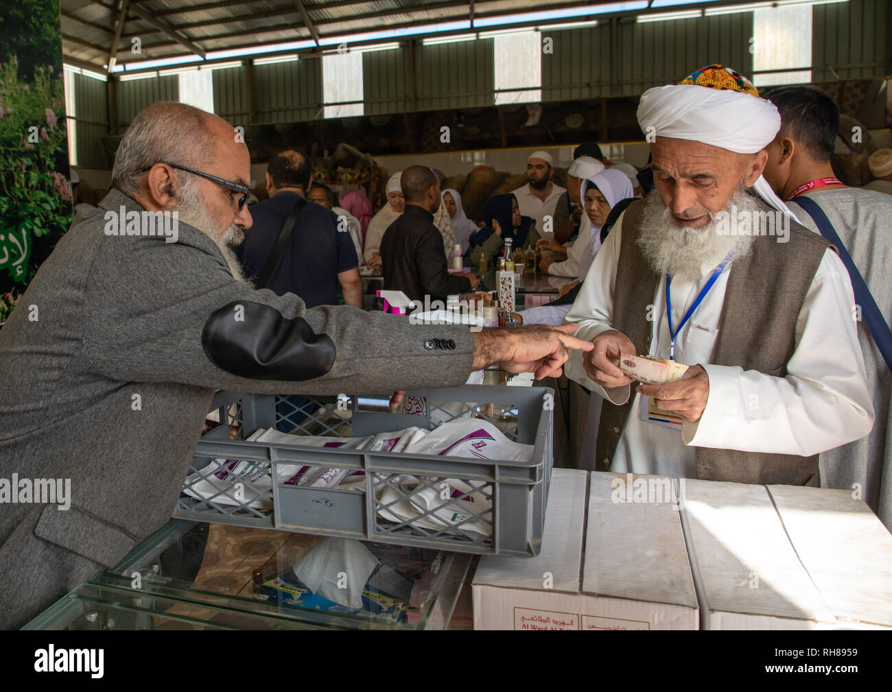 Group of indonesian pilgrims back from hajj buying souvenirs in a rose ...
