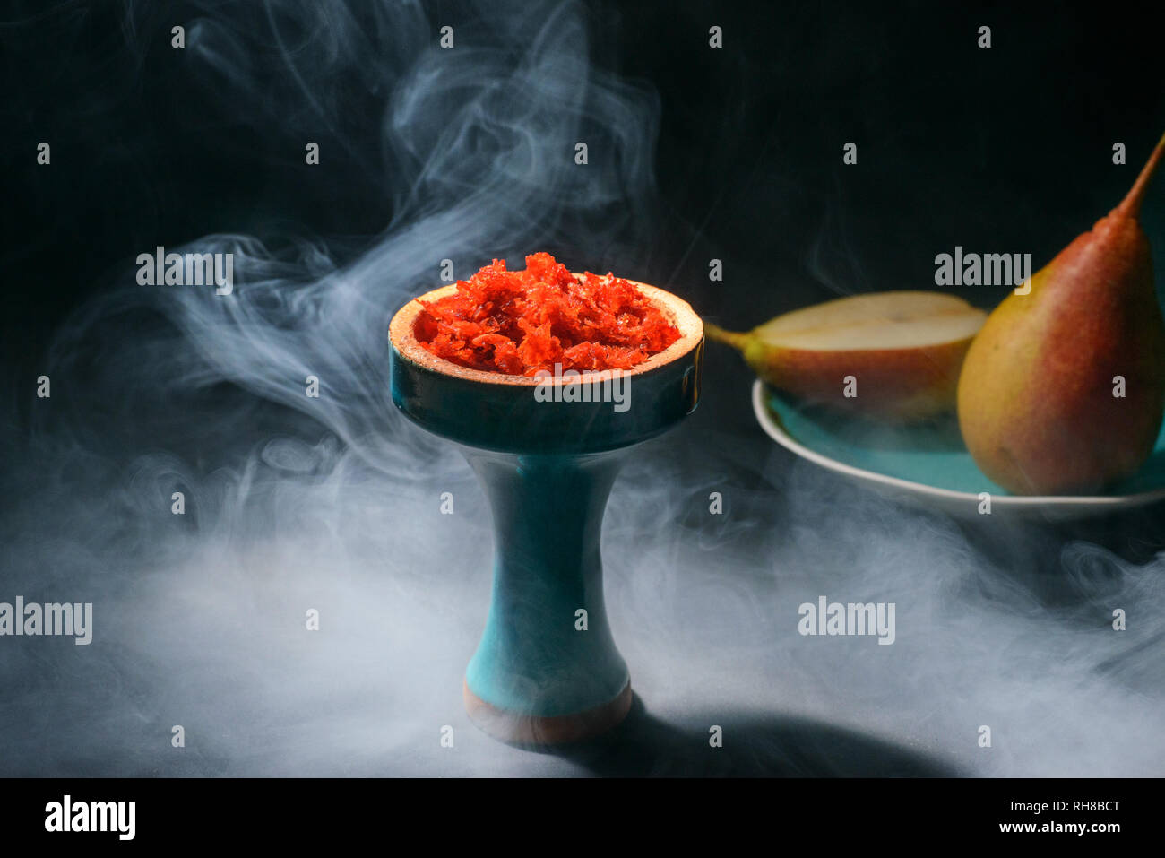 Hookah head full of tobacco molasses decorated with smoke on dark ...