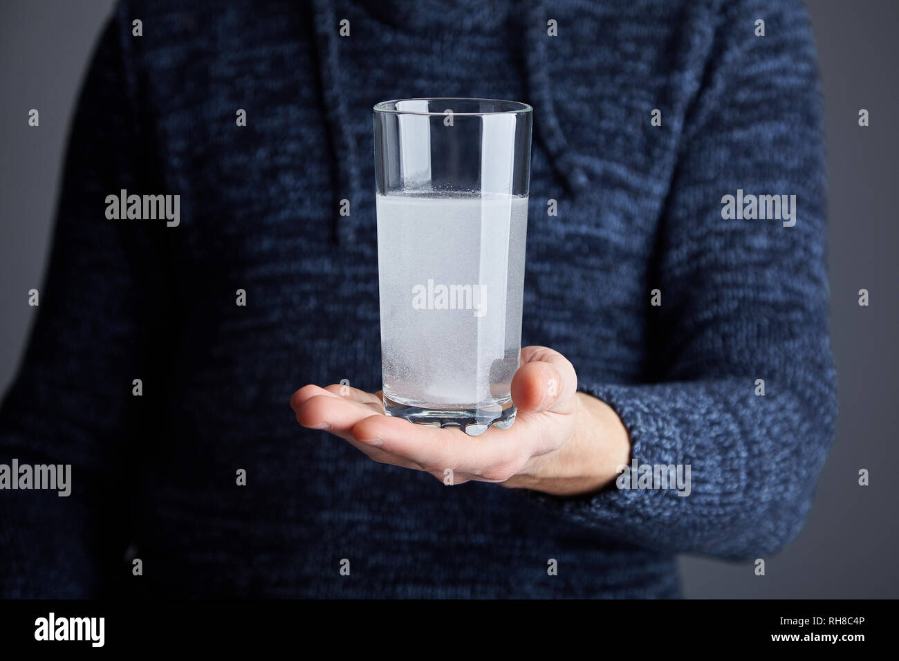 Male ready to dissolve the pill in water. Soluble white pill and a ...