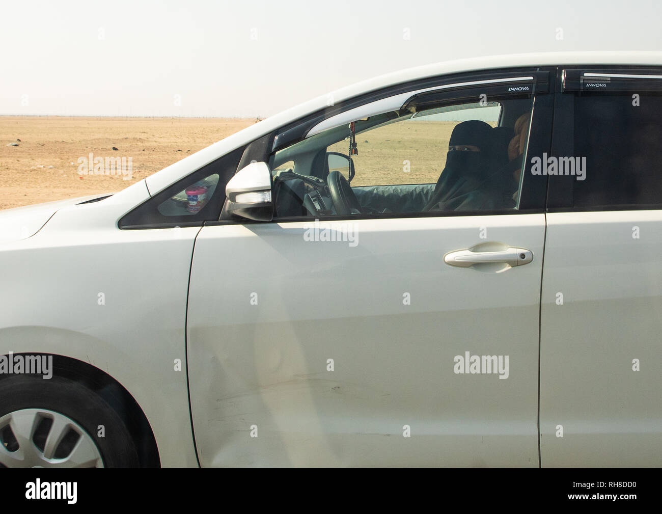 Saudi woman driving alone in a car on the highway, Mecca province ...