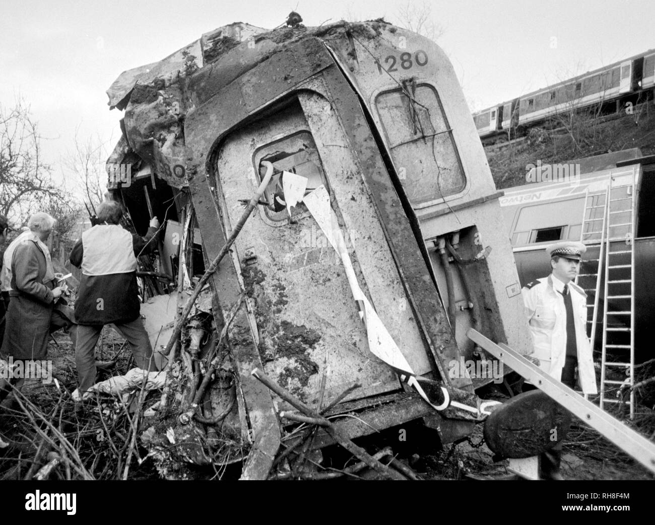 Rescue workers at the carriages which rolled down the rail embankment ...