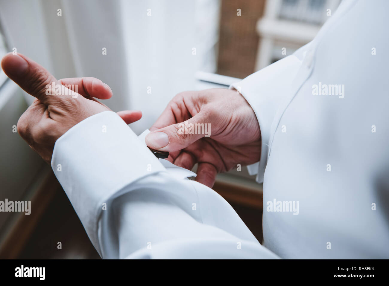 Casual man buttoning up sleeve shirt hi-res stock photography and ...