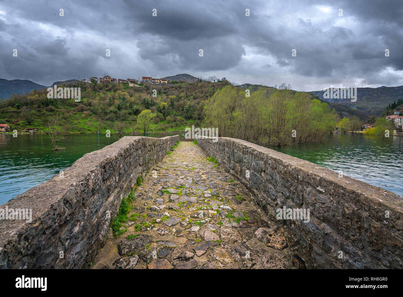 Small ancient stone arch bridge in Rijeka Crnojevica on a rainy day, Montenegro Stock Photo - Alamy