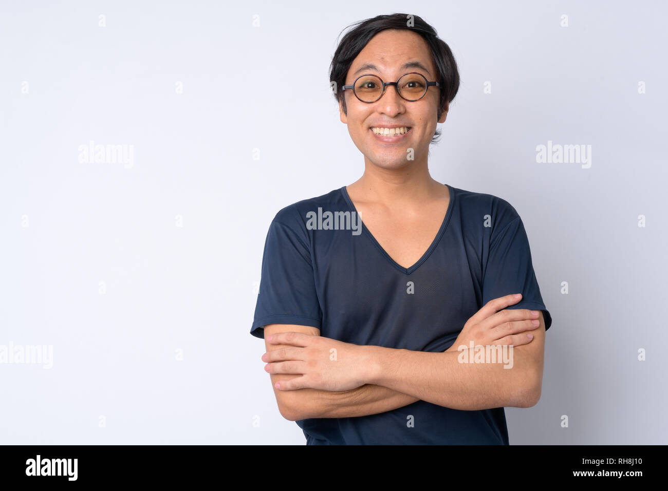 Portrait of happy Japanese man smiling with arms crossed Stock Photo ...