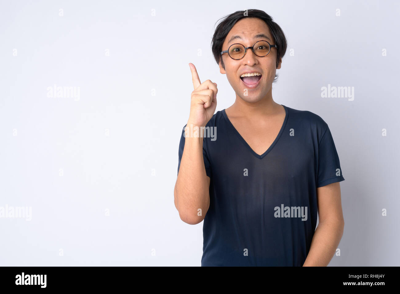 Portrait of happy Japanese man pointing up Stock Photo - Alamy