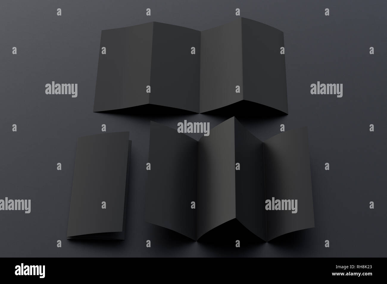 Blank black folded paper leaflet on black background. Eight pages, four ...