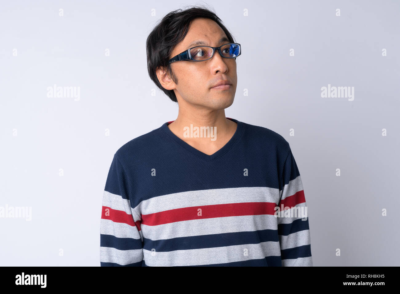 Portrait of Japanese man thinking against white background Stock Photo ...