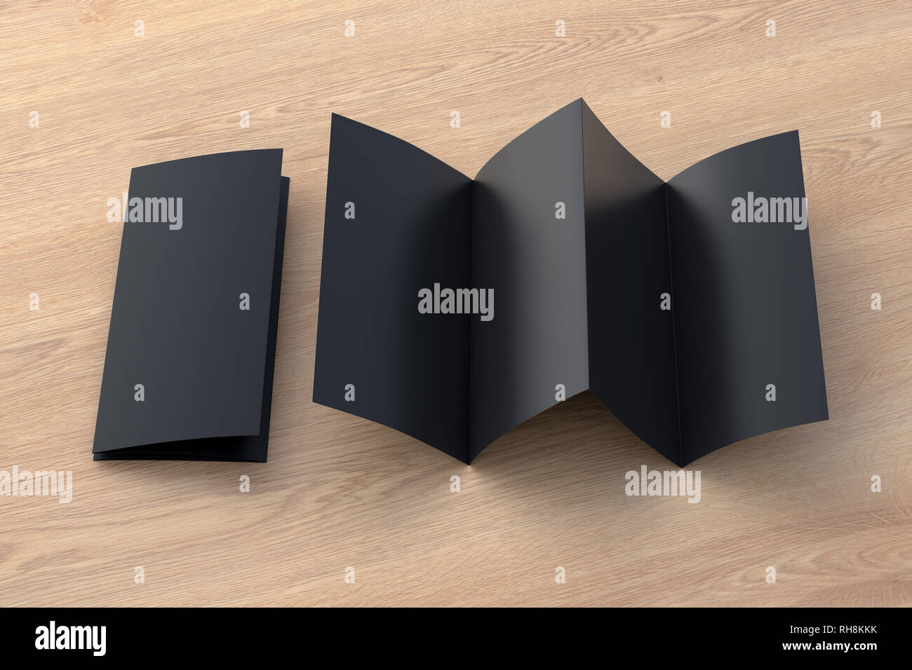 Blank black folded paper leaflet on wooden background. Eight pages ...