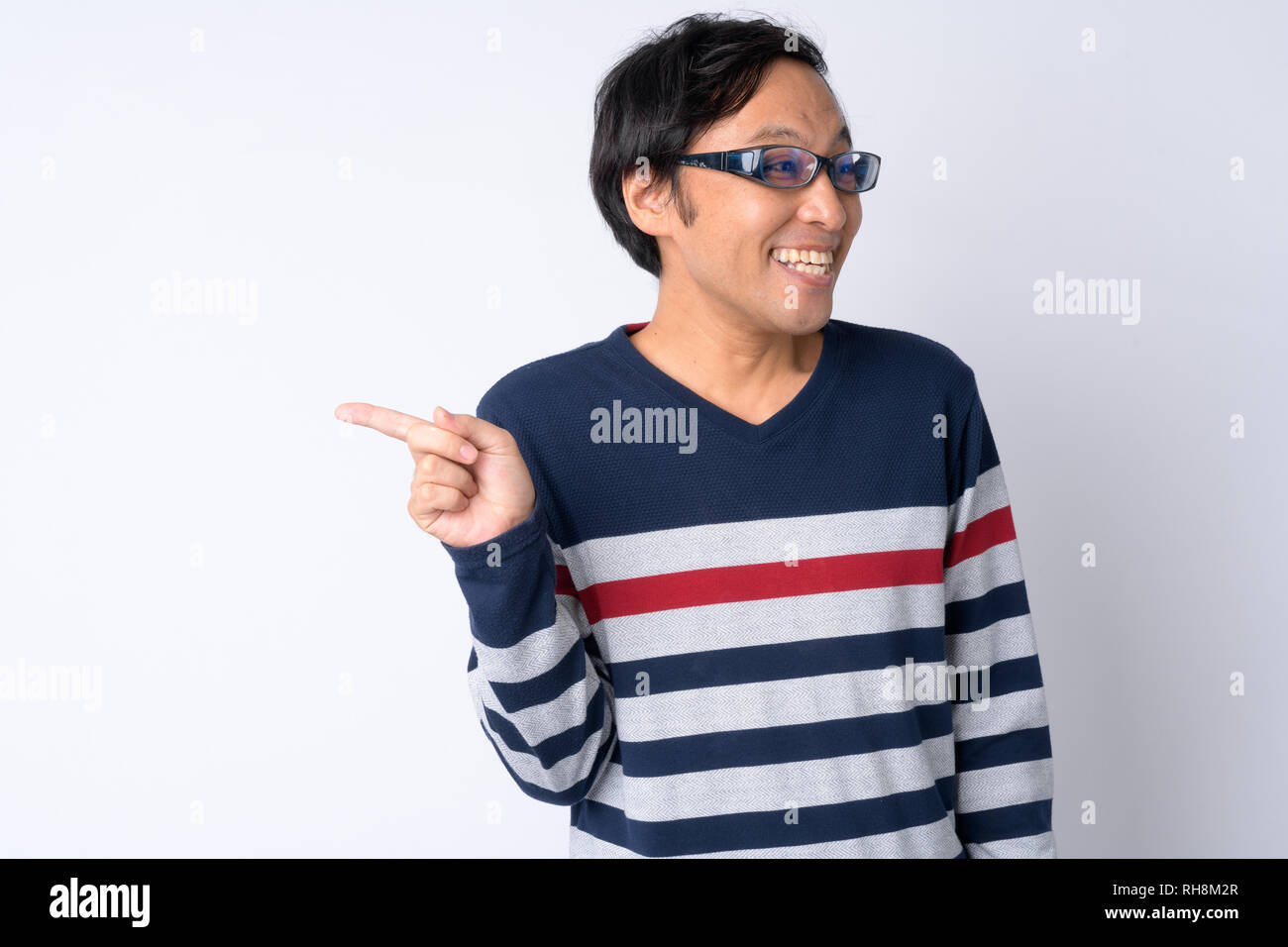 Portrait of happy Japanese man laughing while pointing finger Stock ...