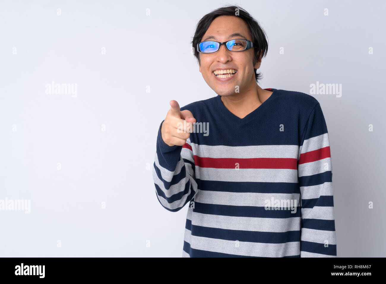 Portrait of happy Japanese man laughing while pointing finger Stock ...